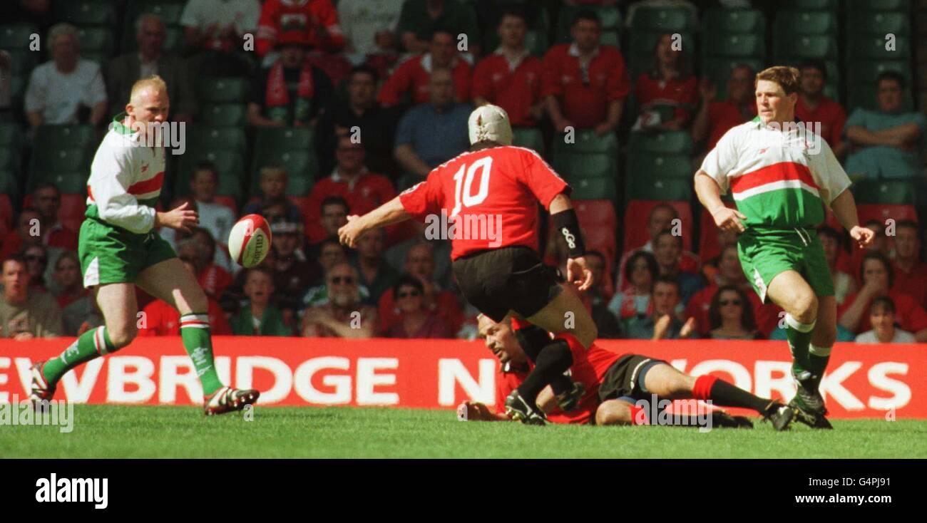 Wales' Neil Jenkins (left) and team mate Scott Gibbs move in on the ...