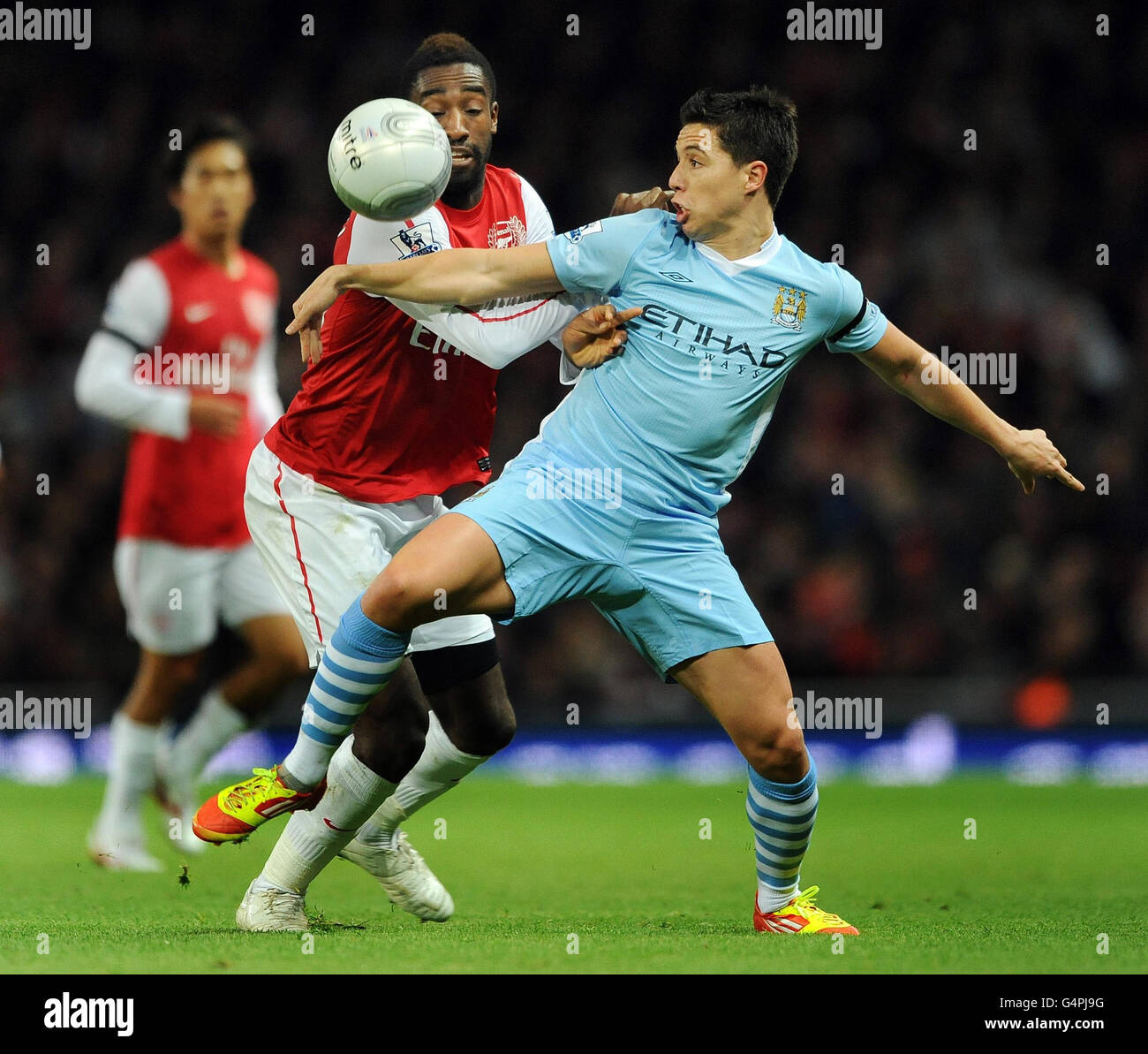 Arsenal's Johan Djourou (left) and Manchester City's Samir Nasri battle ...