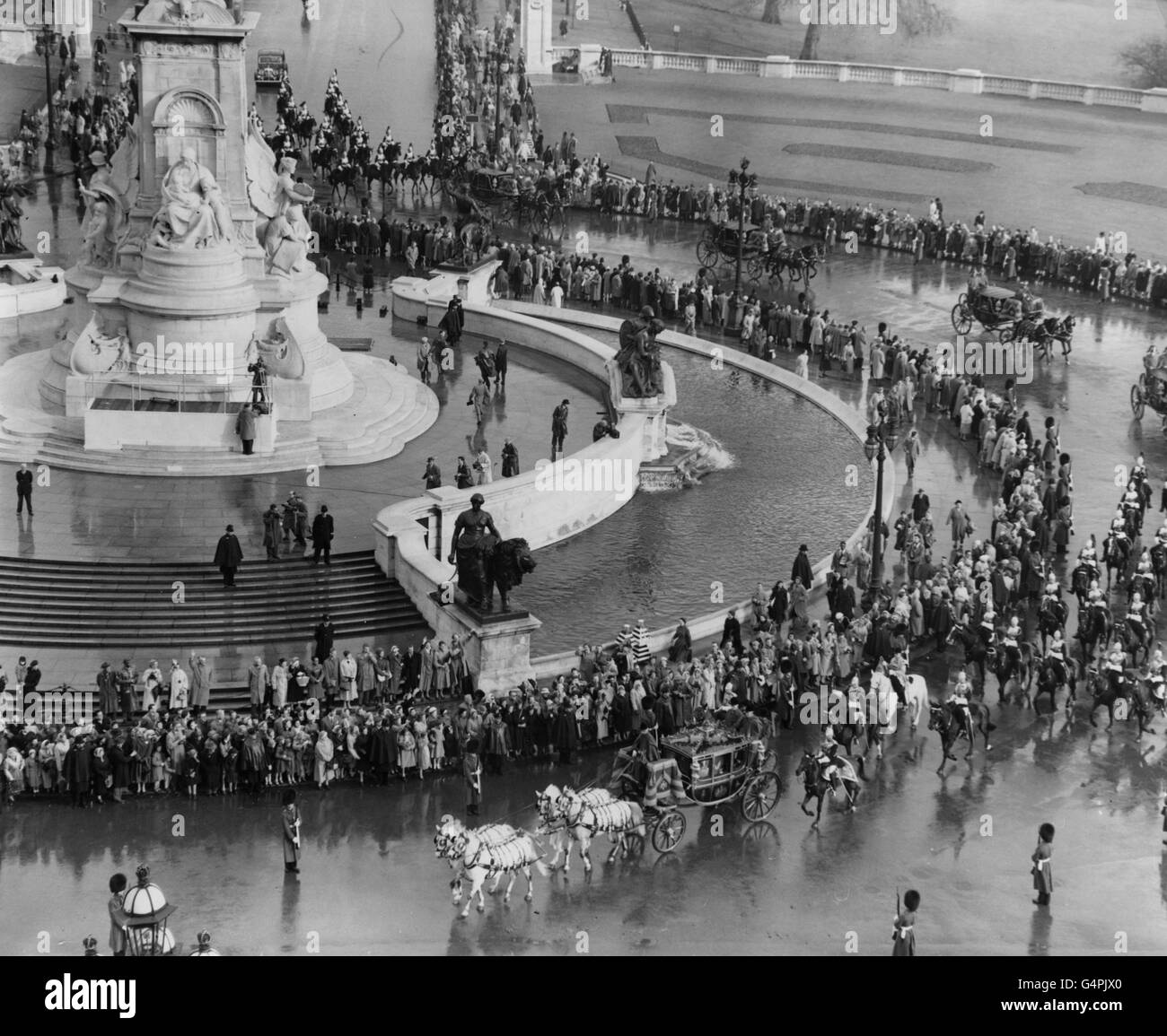 The royal procession, with the Queen and Duke of Edinburgh riding in ...