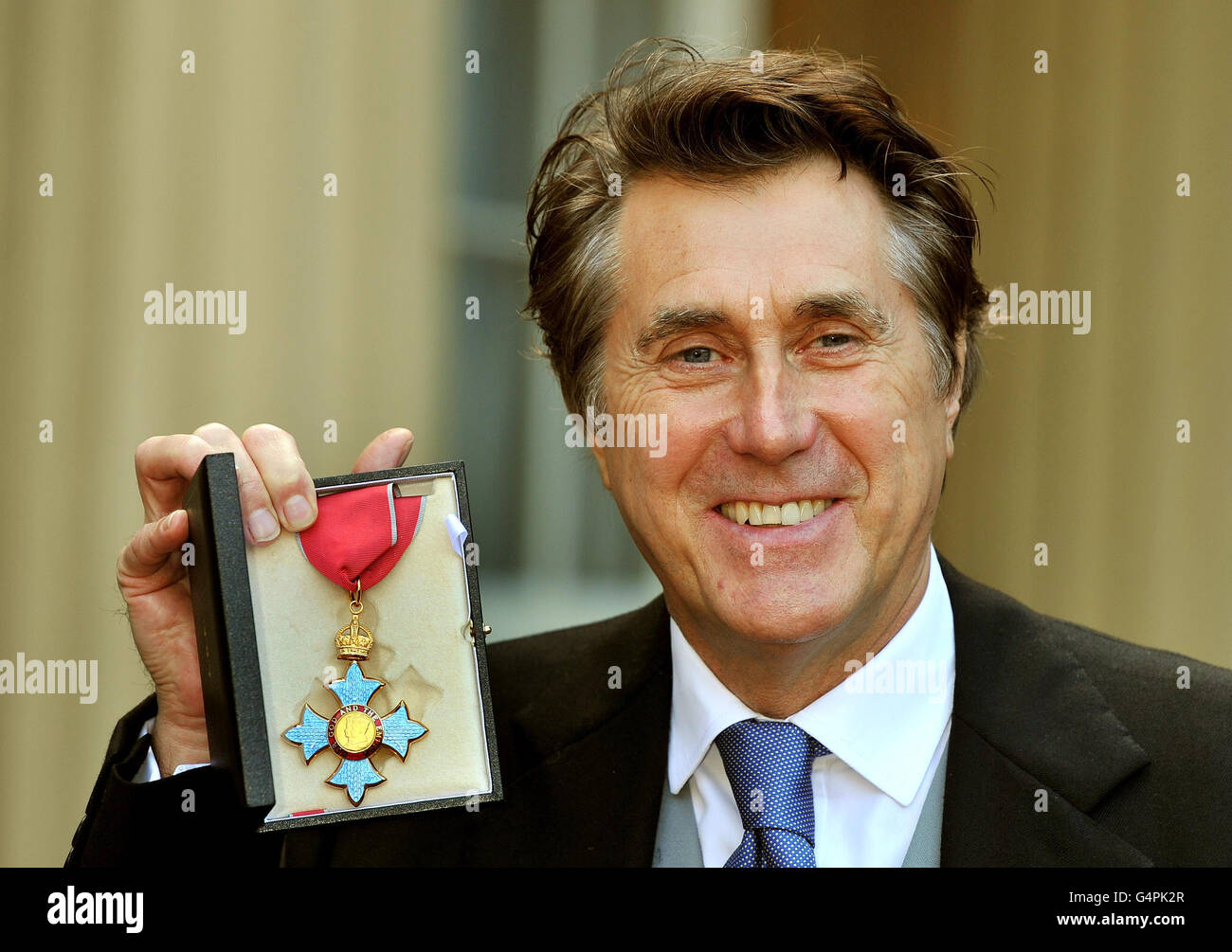 Roxy Music lead singer Bryan Ferry proudly holds his CBE, after he ...