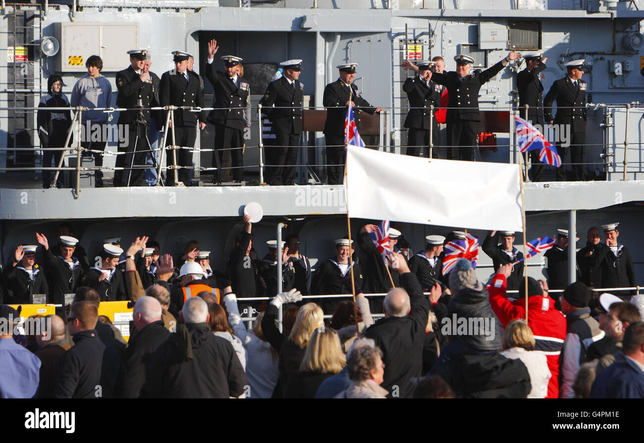 Crew members aboard HMS Edinburgh wave to their families as they return ...