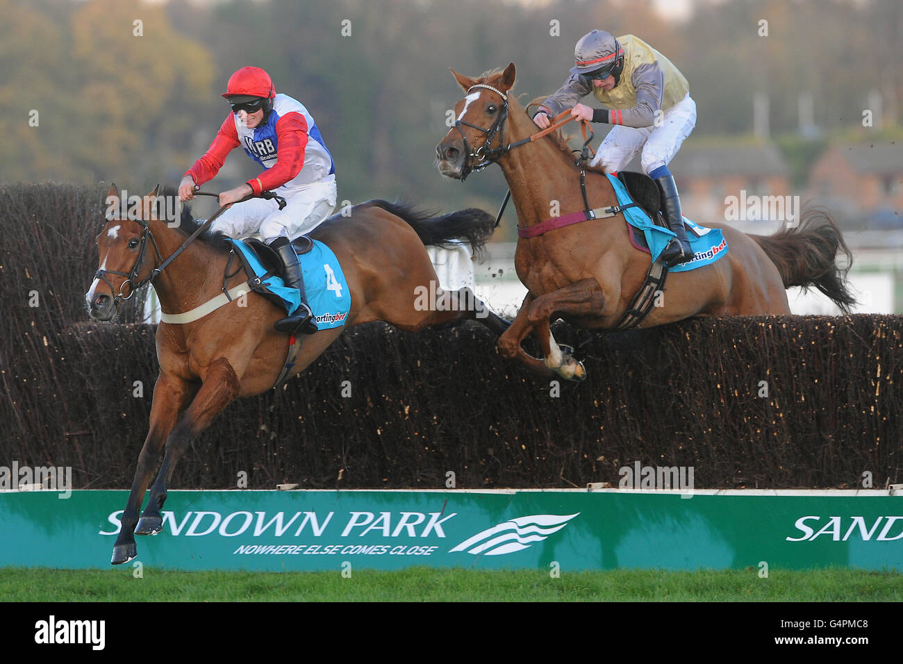 Golan Way ridden by Marc Goldstein (left) jumps the last fence and goes ...