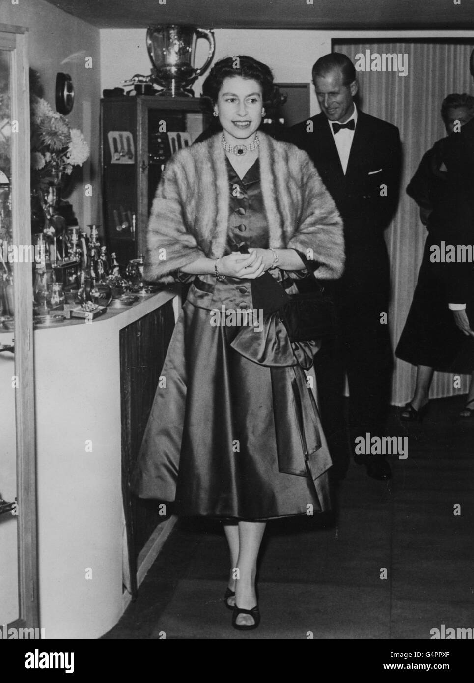Queen Elizabeth II, accompanied by the Duke of Edinburgh, arriving at ...