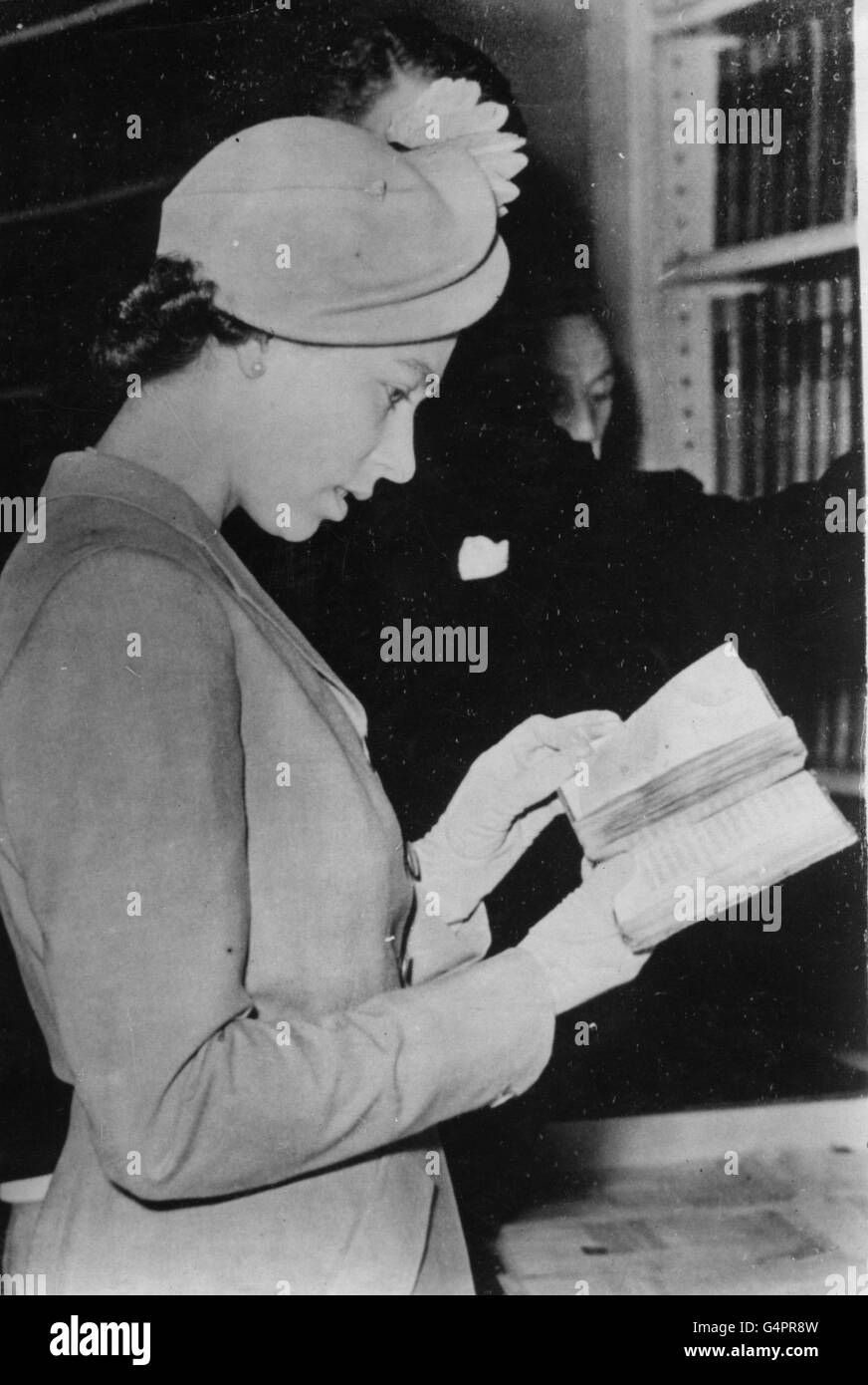 Queen Elizabeth II examines a book handwritten by her ancestor, Queen ...