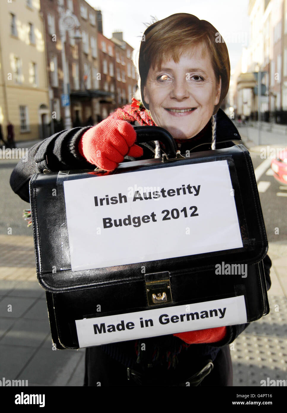 A protestor from the peoples movement dressed as German Chancellor ...