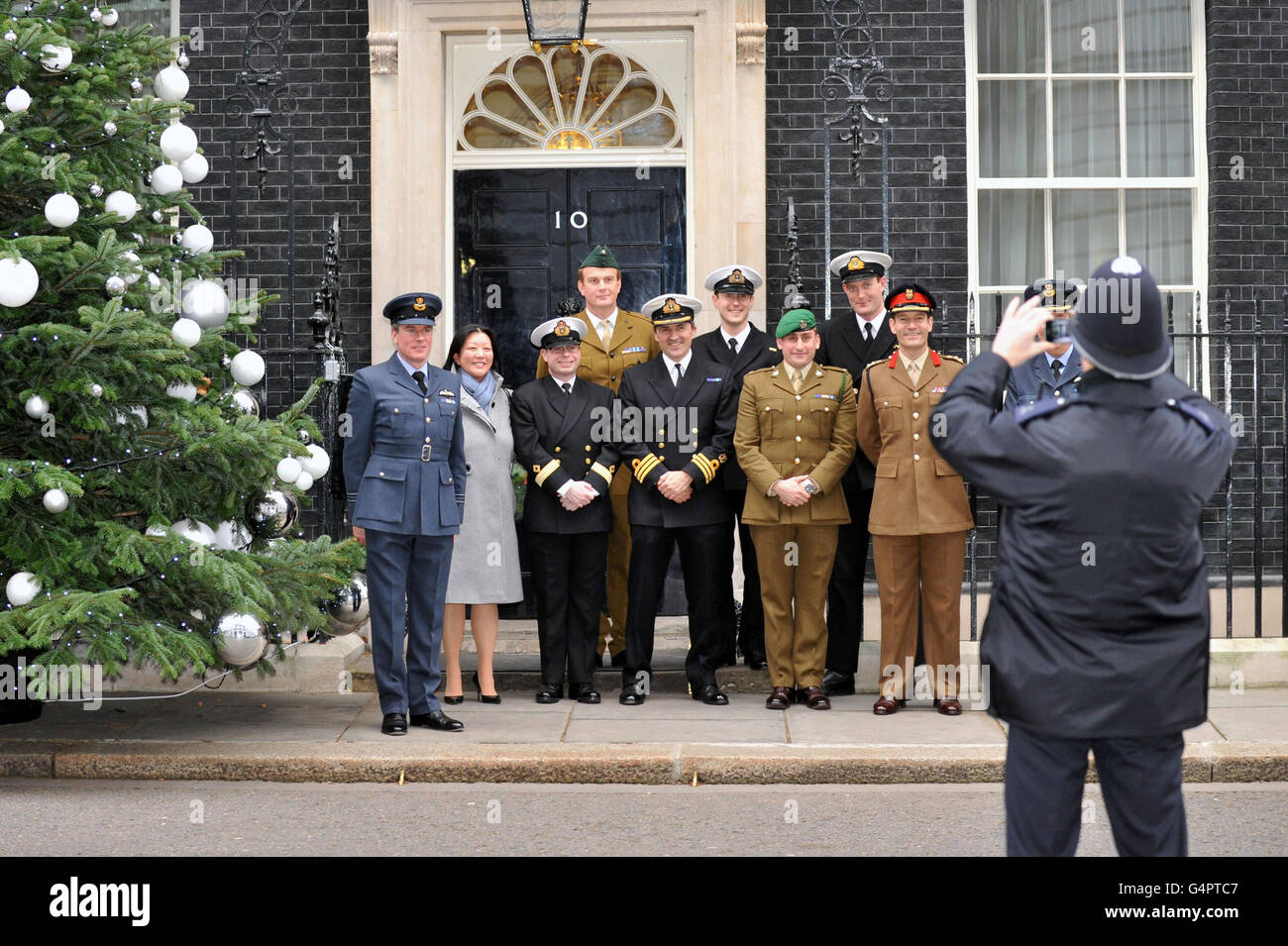 A police officer takes a photo of guests leaving 10 Downing Street ...