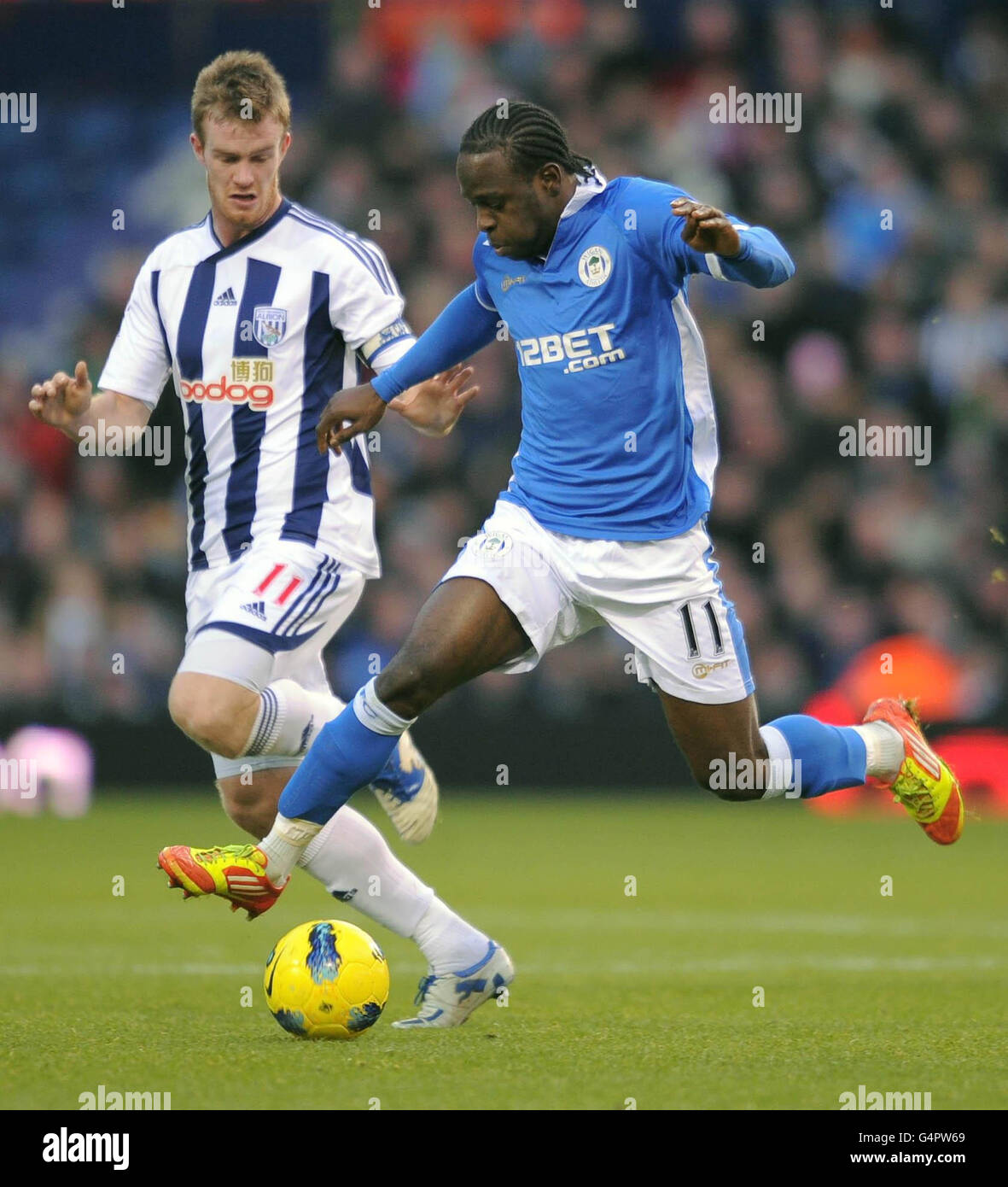 West Bromwich Albion's Chris Brunt and Wigan Athletics Victor Moses ...