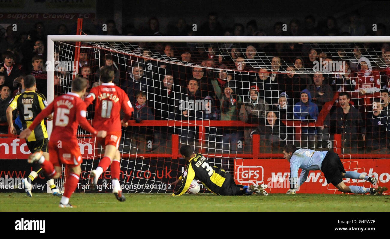 Burton Albion's Aaron Webster (centre) turns the ball into his own net ...