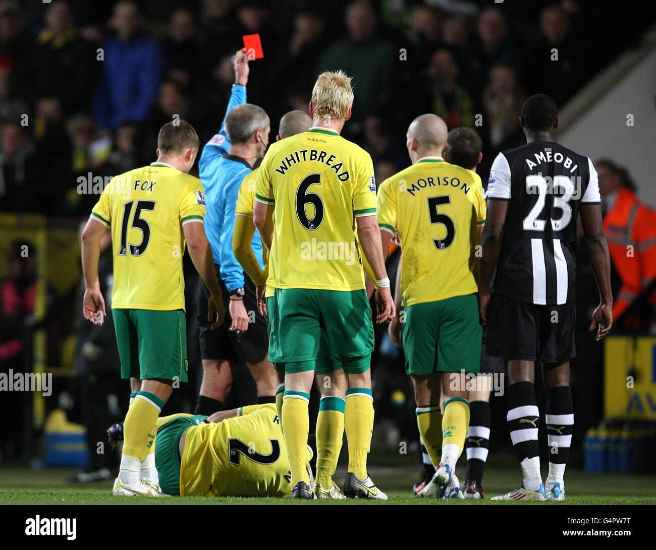 Referee Martin Atkinson (left) shows Newcastle United's Dan Gosling the ...