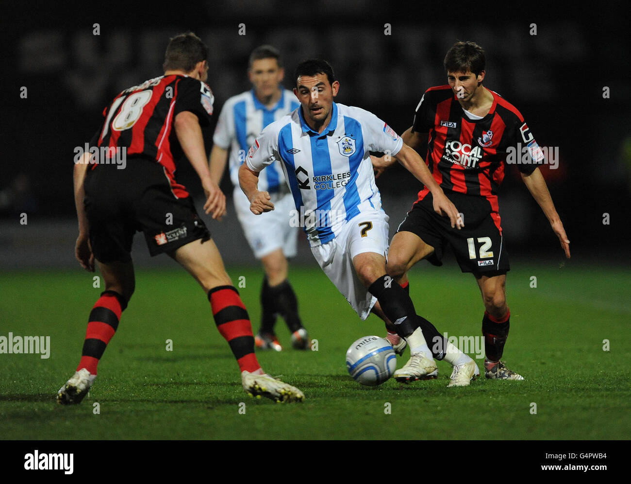 Huddersfield Town's Gary Roberts (centre) takes on Bournemouth's Simon ...