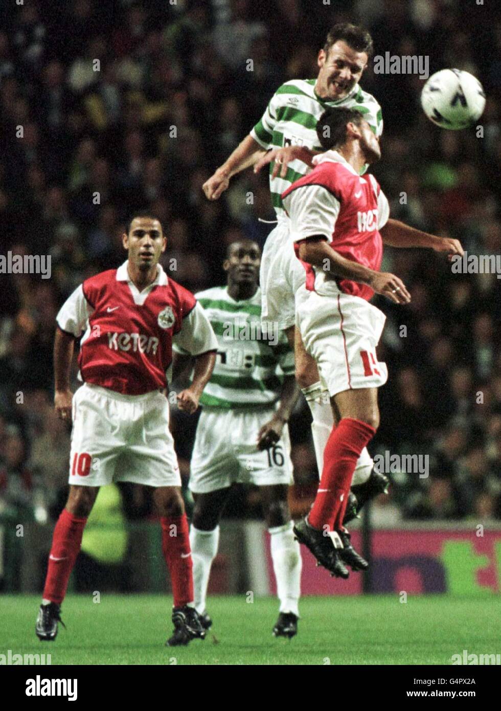 Celtic's Craig Burley takes the ball in the air from Salim Toema of ...