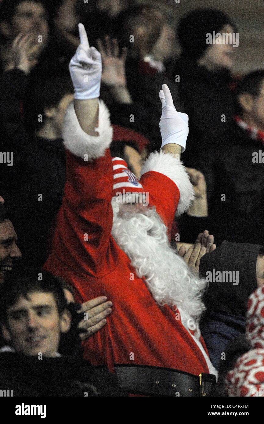 A Stoke City fan dressed as Santa Claus celebrates in the stands Stock ...