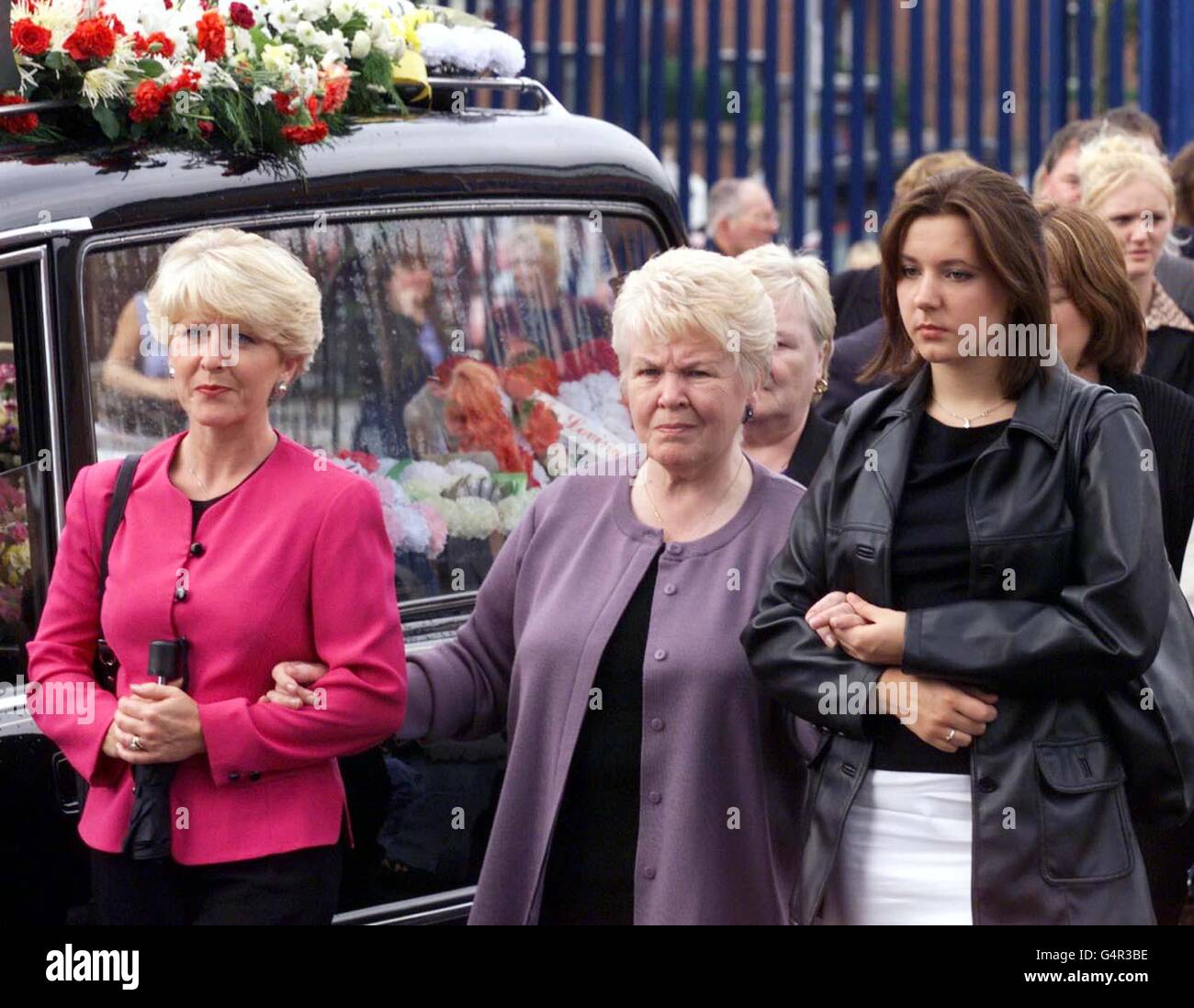 Margaret McKinney (purple Jacket) follows her sons coffin for burial at ...