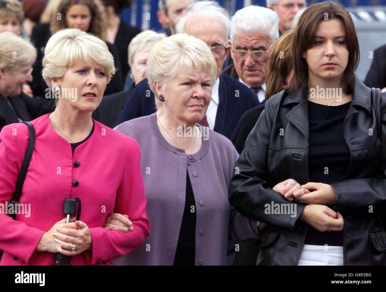 Margaret McKinney (purple Jacket) follows her sons coffin for burial at ...