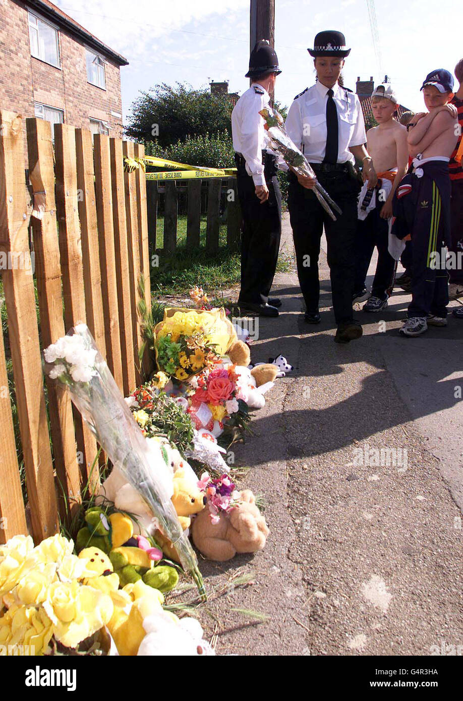 A Policewoman lays flowers at the property in Calvert Terrace, Murton ...