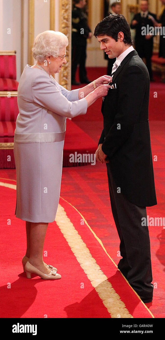 England cricketer Alastair Cook is made an MBE by the Queen during an ...
