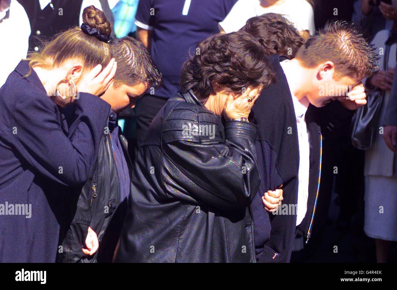 Ellen Barras, centre, prays as she arrives with daughters (un-named ...