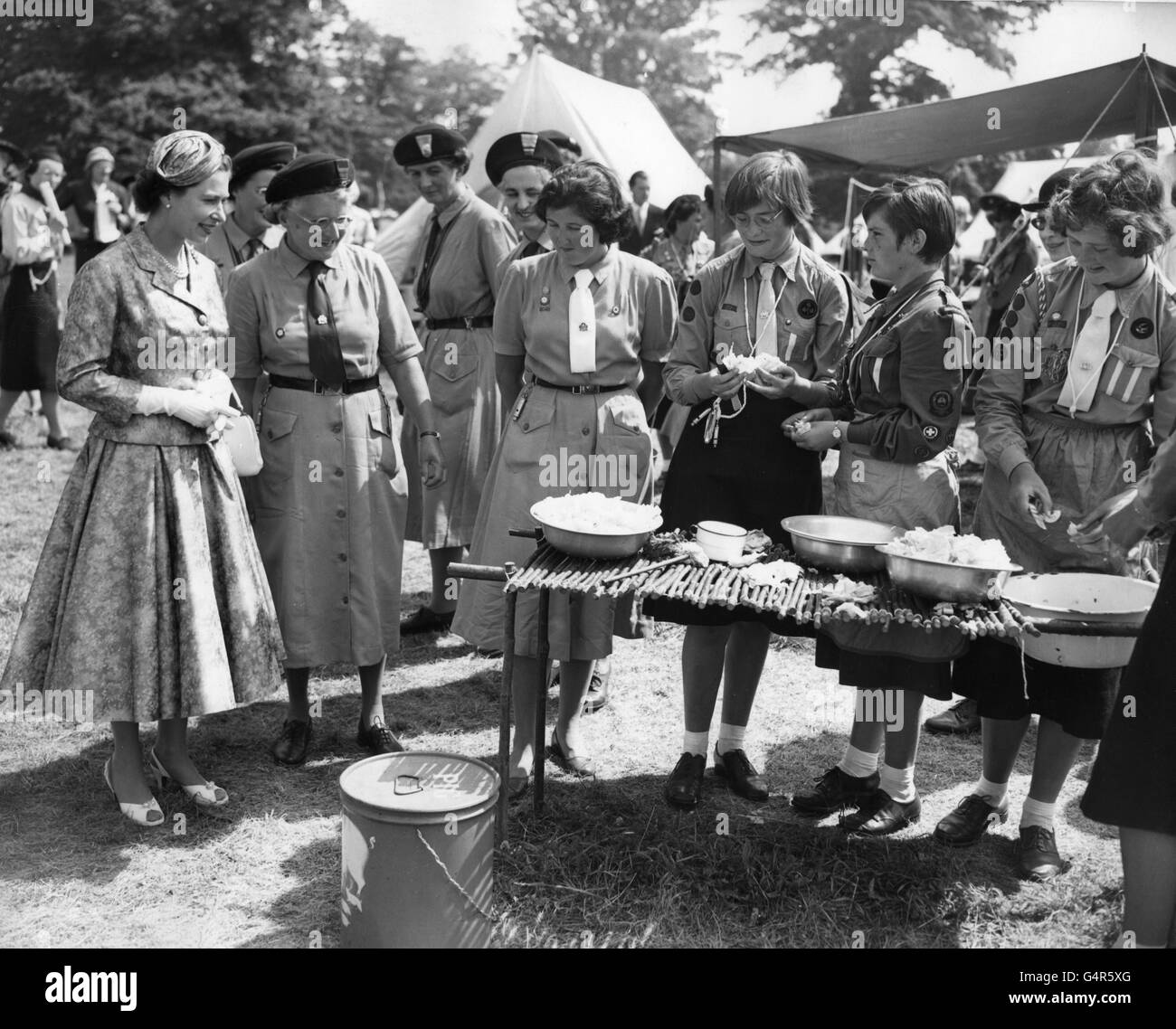 Queen Elizabeth II, patron of the Girl Guides Association, watching ...