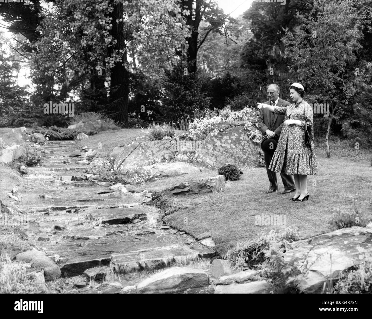 Queen Elizabeth II points to a landscape feature that caught her eye ...