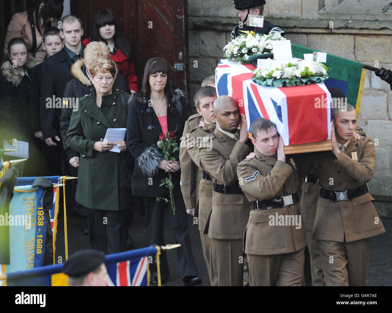 The coffin of Rifleman Sheldon Steel is followed by his family led by ...