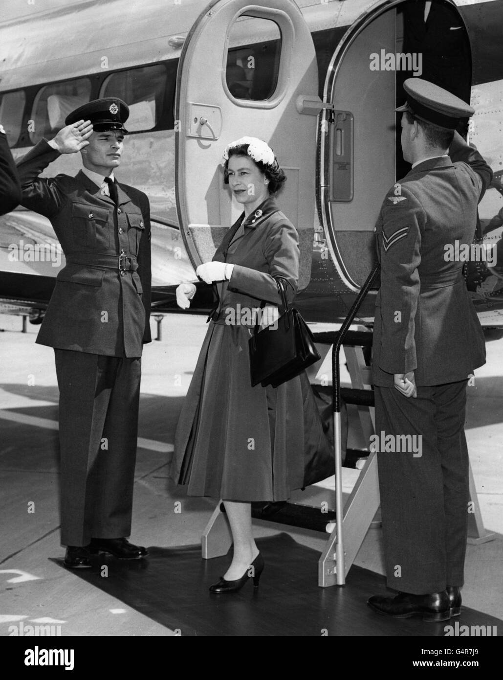 Queen Elizabeth II steps from a Heron of the Queen's Flight on her ...
