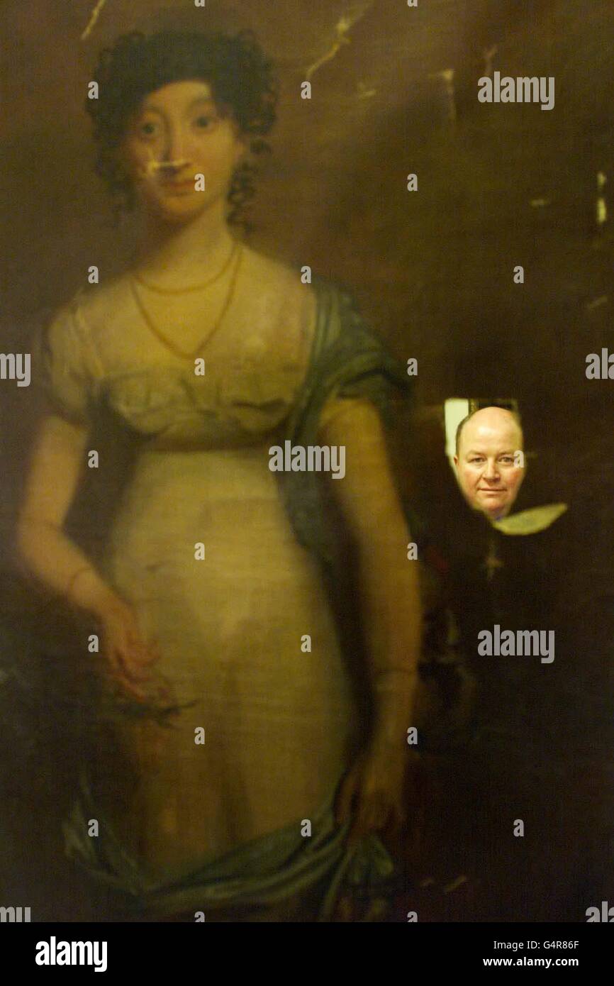 Auctioneer George Mealy peers through an 18th century painting, damaged ...