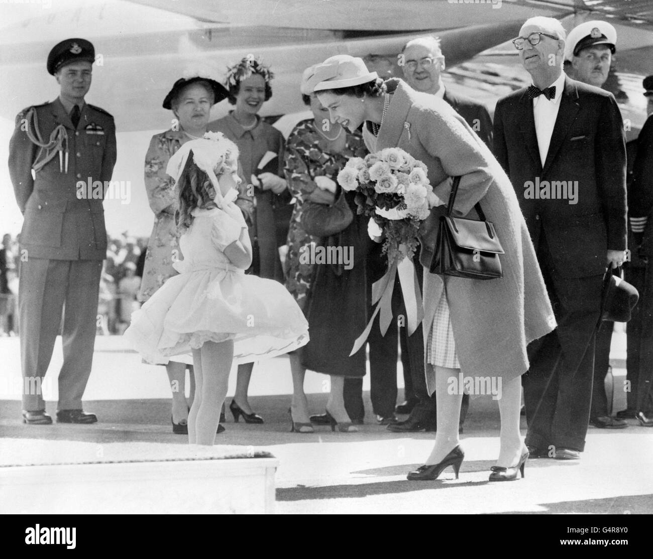 Queen Elizabeth II holds a conversation with Dale Russell after she had ...