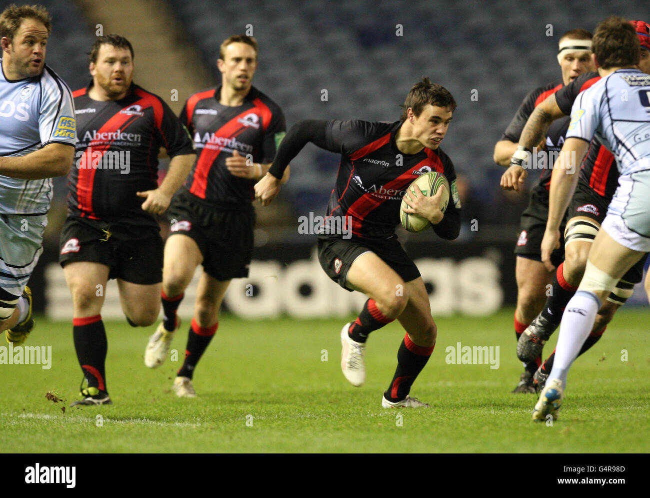 Edinburgh's Lee Jones holds off Cardiff during the Heineken Cup match ...
