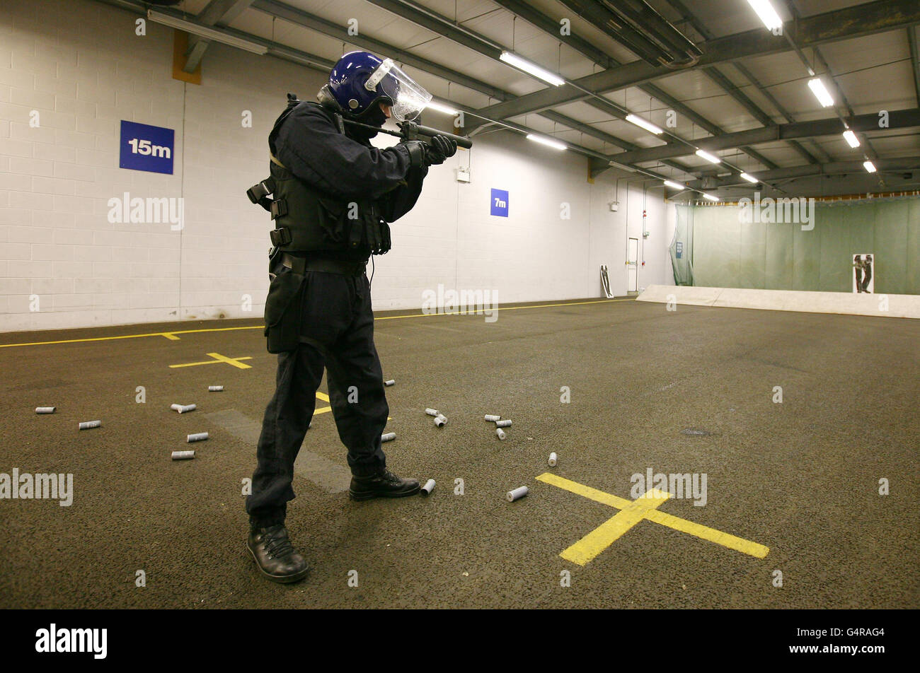 A police officer demonstrates the Common Weapons System on a firing ...