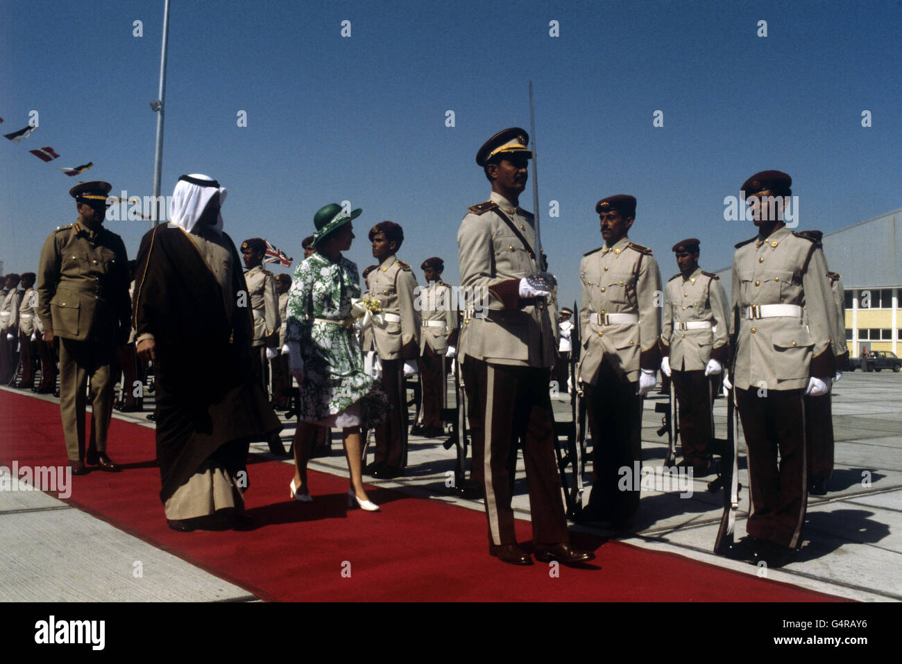 Queen Elizabeth II inspects the Guard of Honour on arrival at Doha Port ...