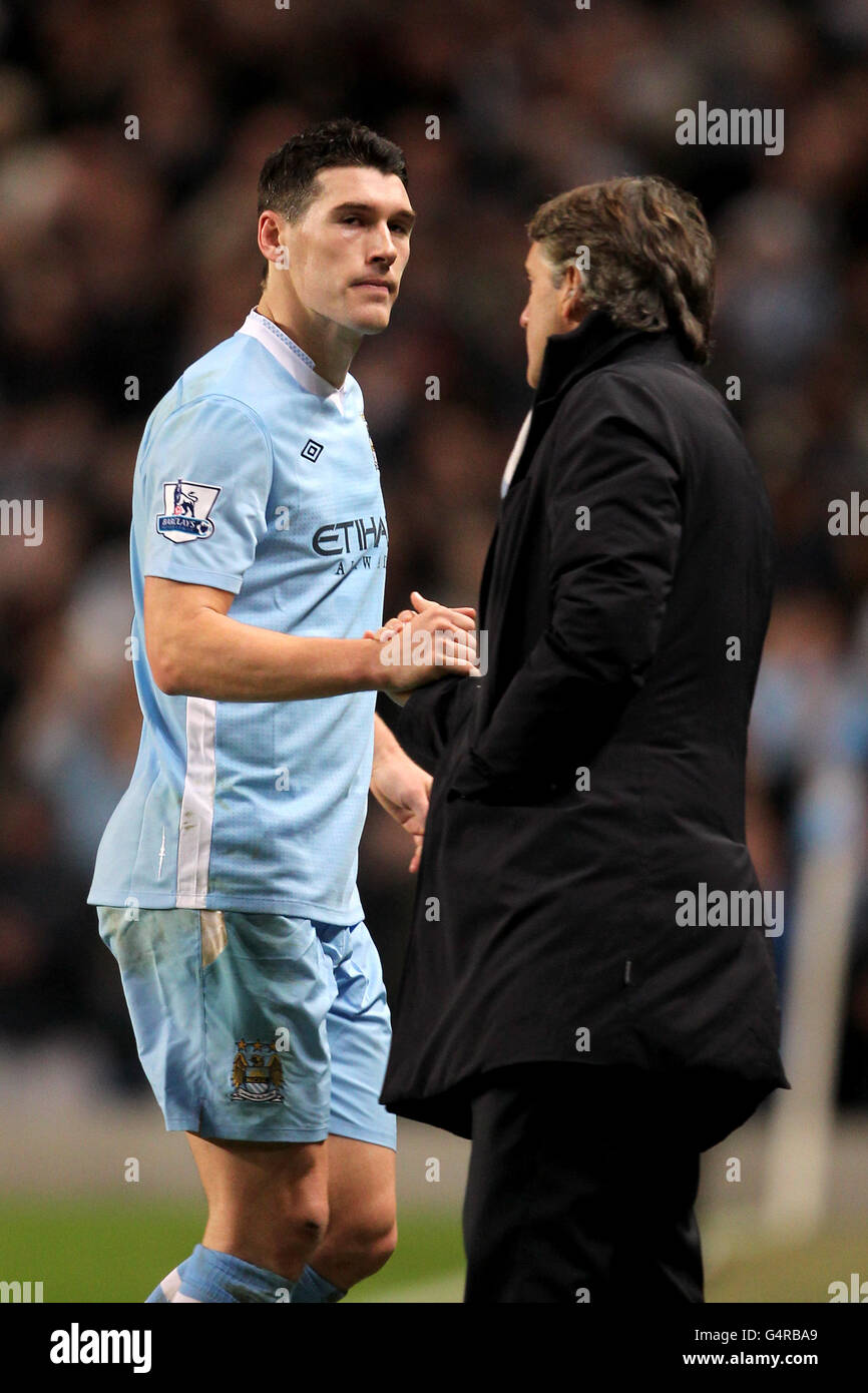 Manchester citys barry hands with his manager roberto mancini hi-res ...