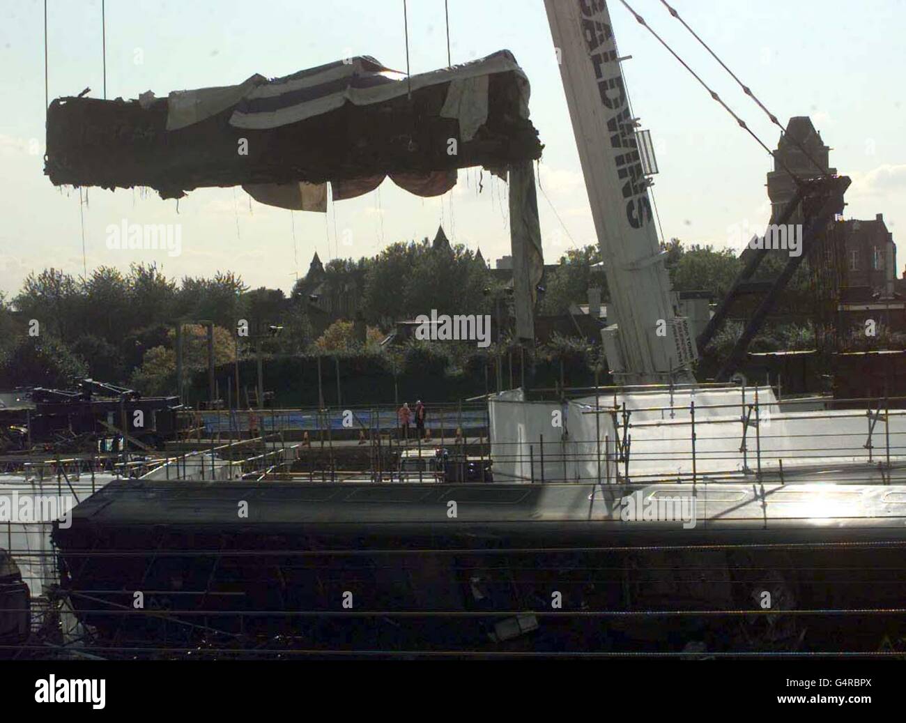 The wrecked and burnt out Great Western train carriage H is lifted from ...