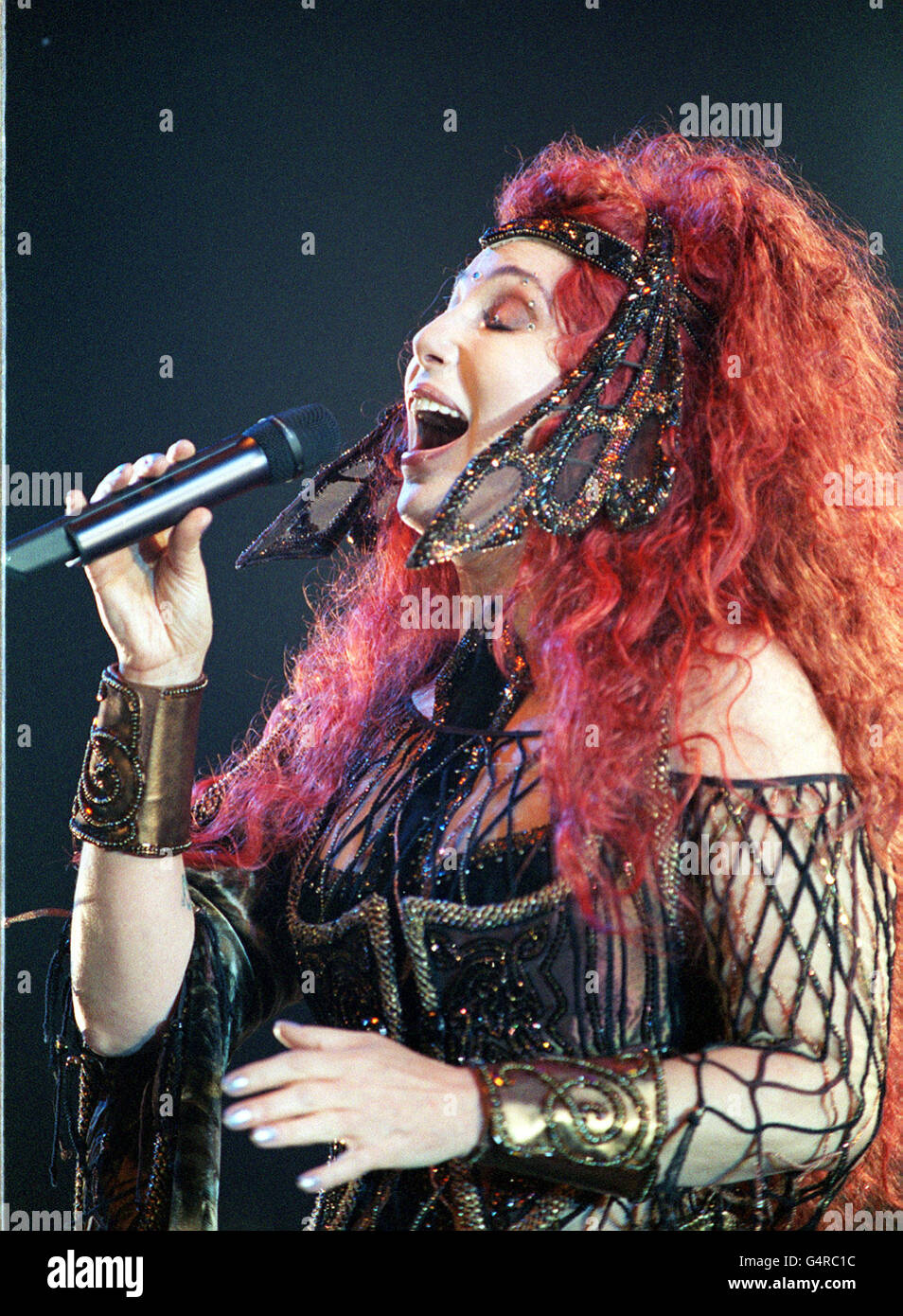 American pop singer Cher performs on stage at London's Wembley Arena as ...