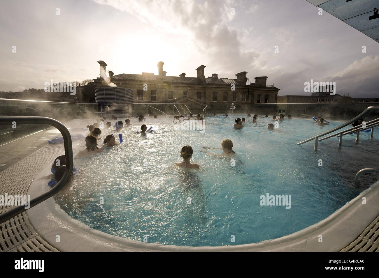 Bathers enjoy the mild weather and warm naturally heated waters on the ...
