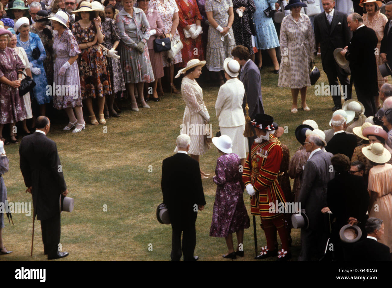 Queen Elizabeth II talking to guests at a garden party at Buckingham ...