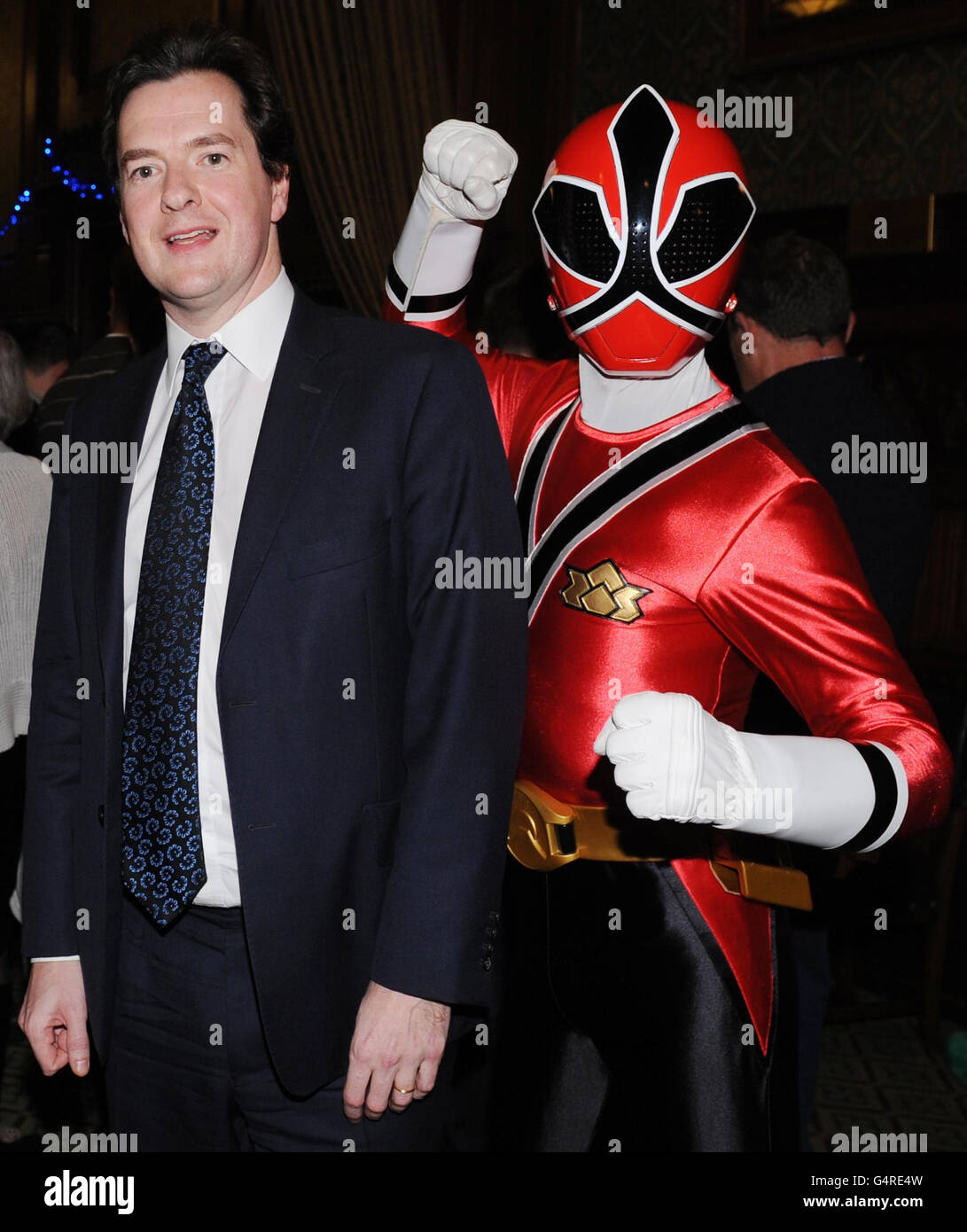 Chancellor George Osborne has his picture taken with a person dressed ...