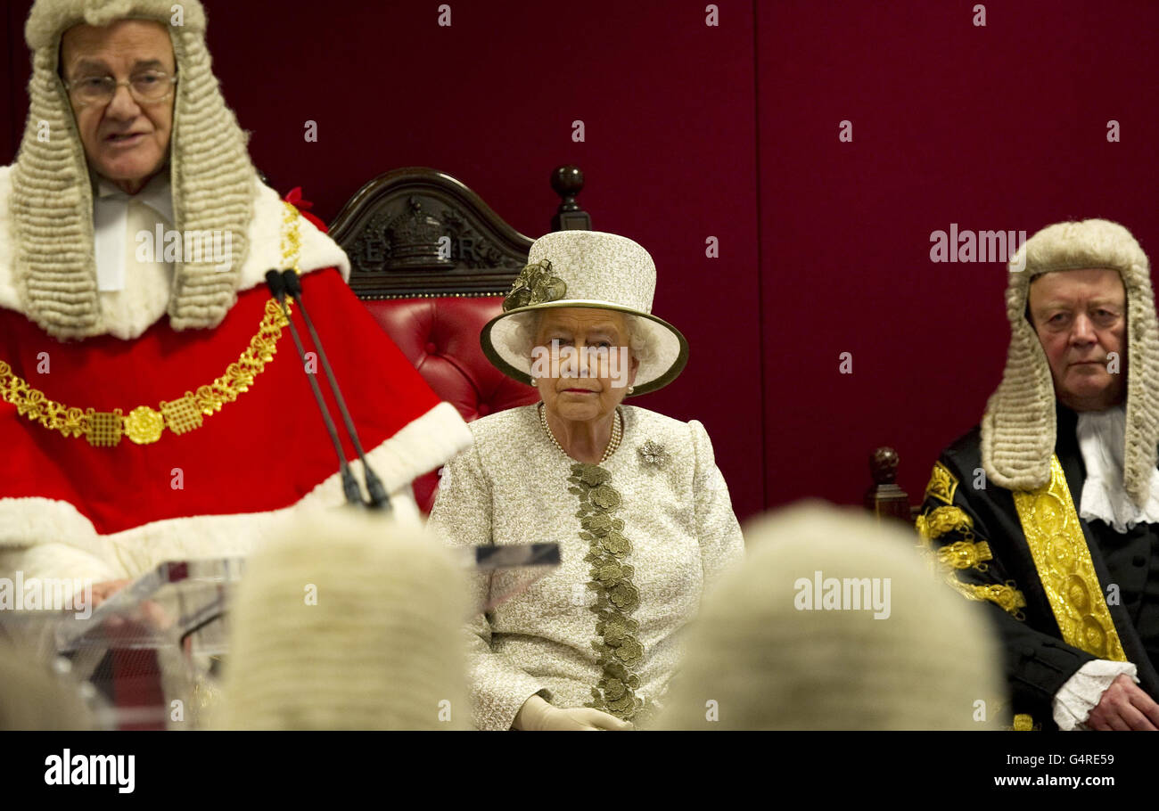Queen Elizabeth II sits listening to a High Court judge speaking as she ...
