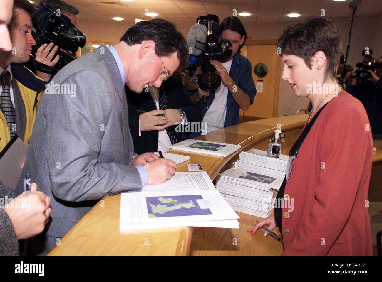 Journalists sign for copies of the Patten report in Belfast early ...
