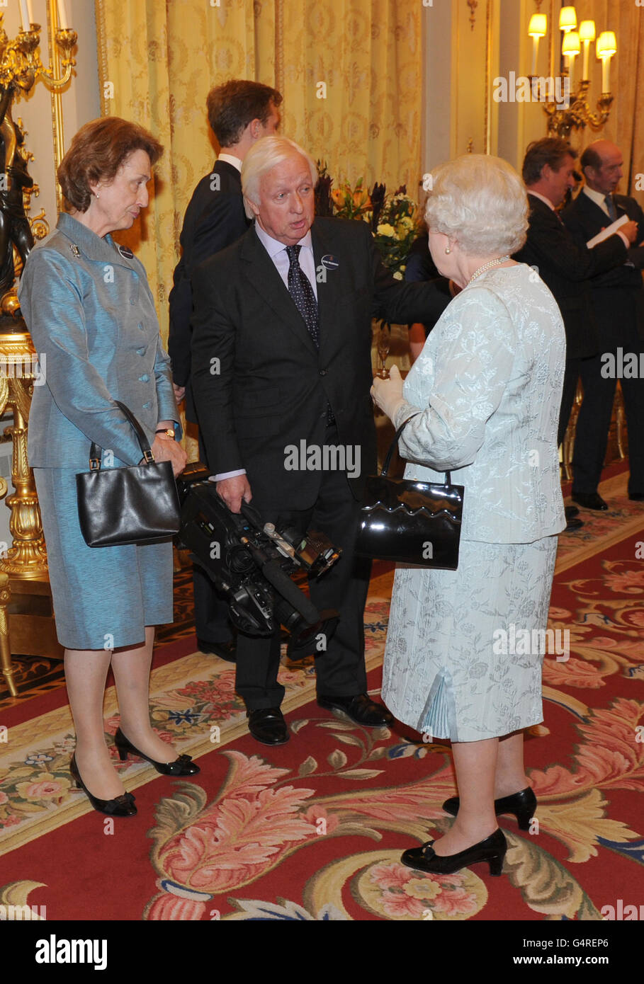 Royal Cameraman Peter Wilkinson speaks with the Queen as she and the ...