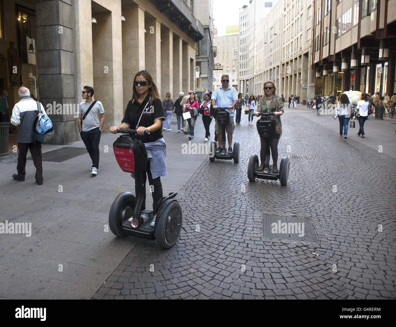 City Views, Milan, Italy. People ride Segways around the centre of ...