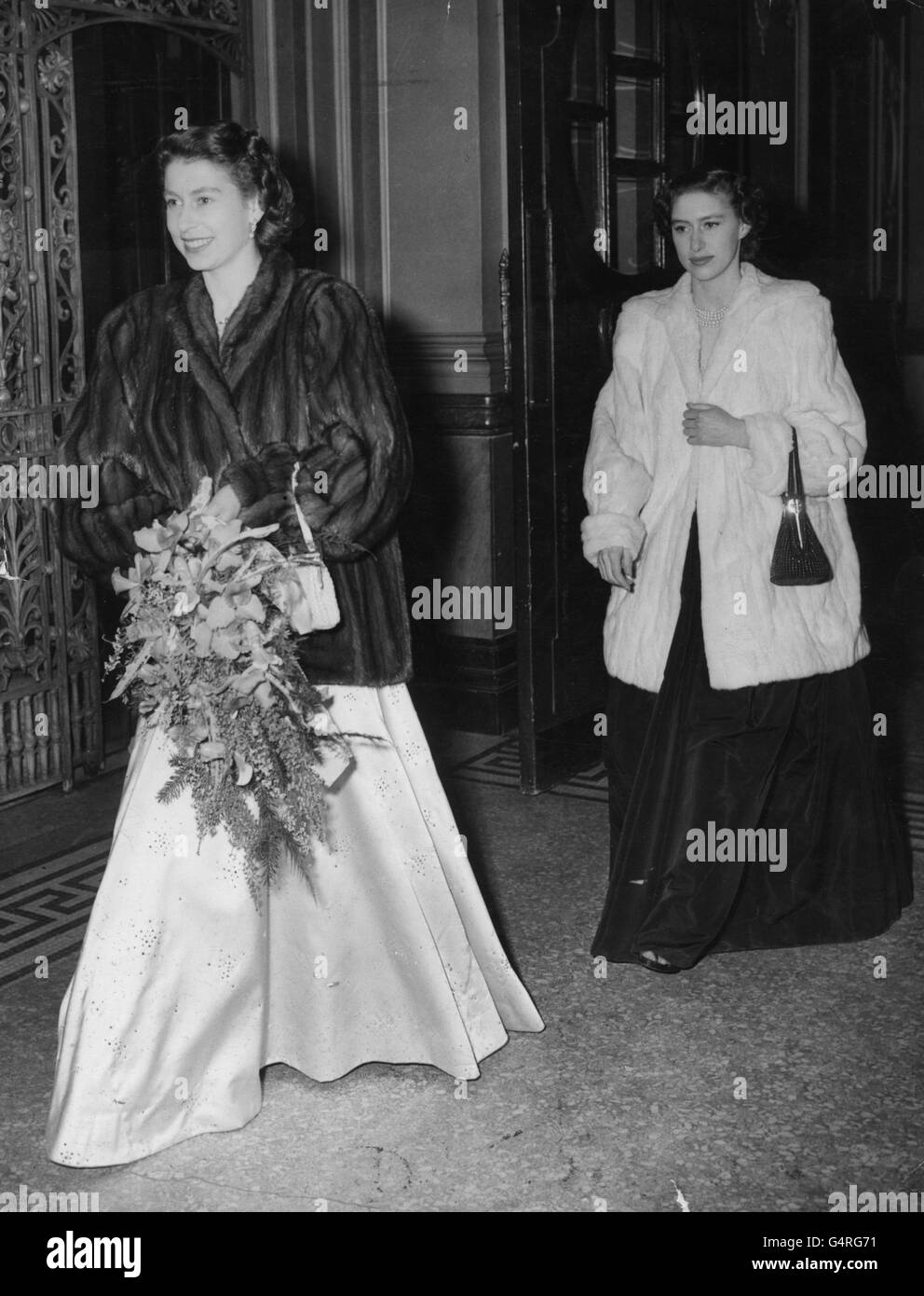 Queen Elizabeth II, followed by Princess Margaret, leaves the Coliseum ...