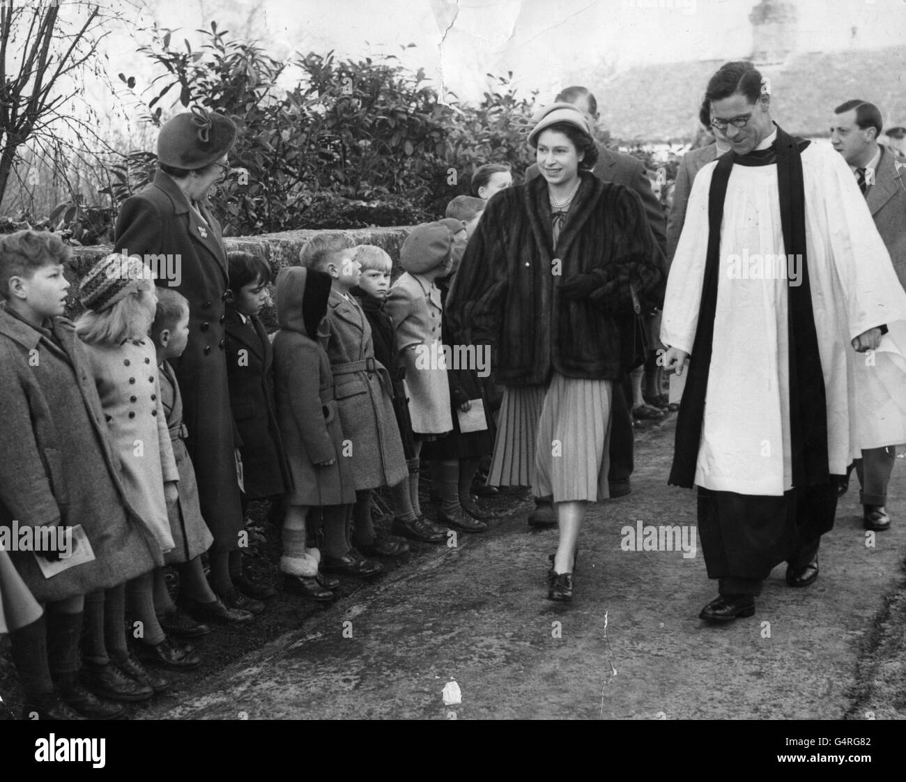 Queen Elizabeth II smiling at village children who greeted her as she ...