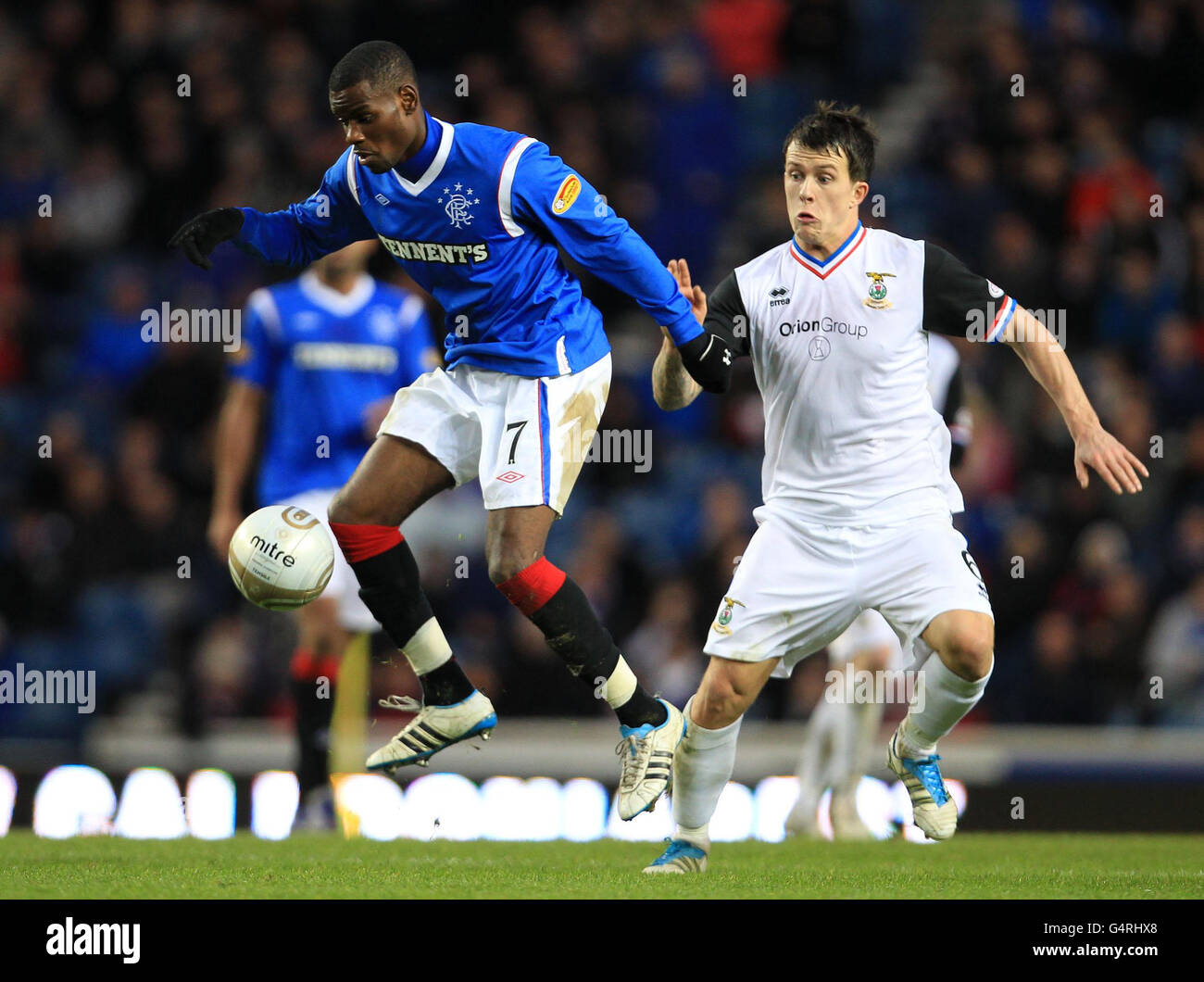 Rangers' Maurice Edu and Inverness's Lee Cox (right) in action during ...