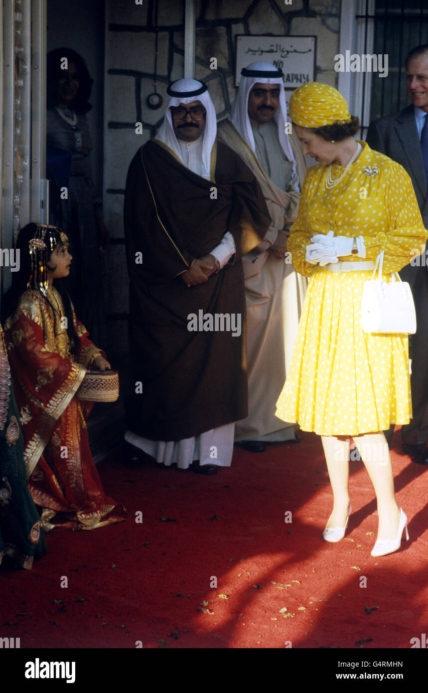 Queen Elizabeth II stops to admire the traditional dress of a young ...