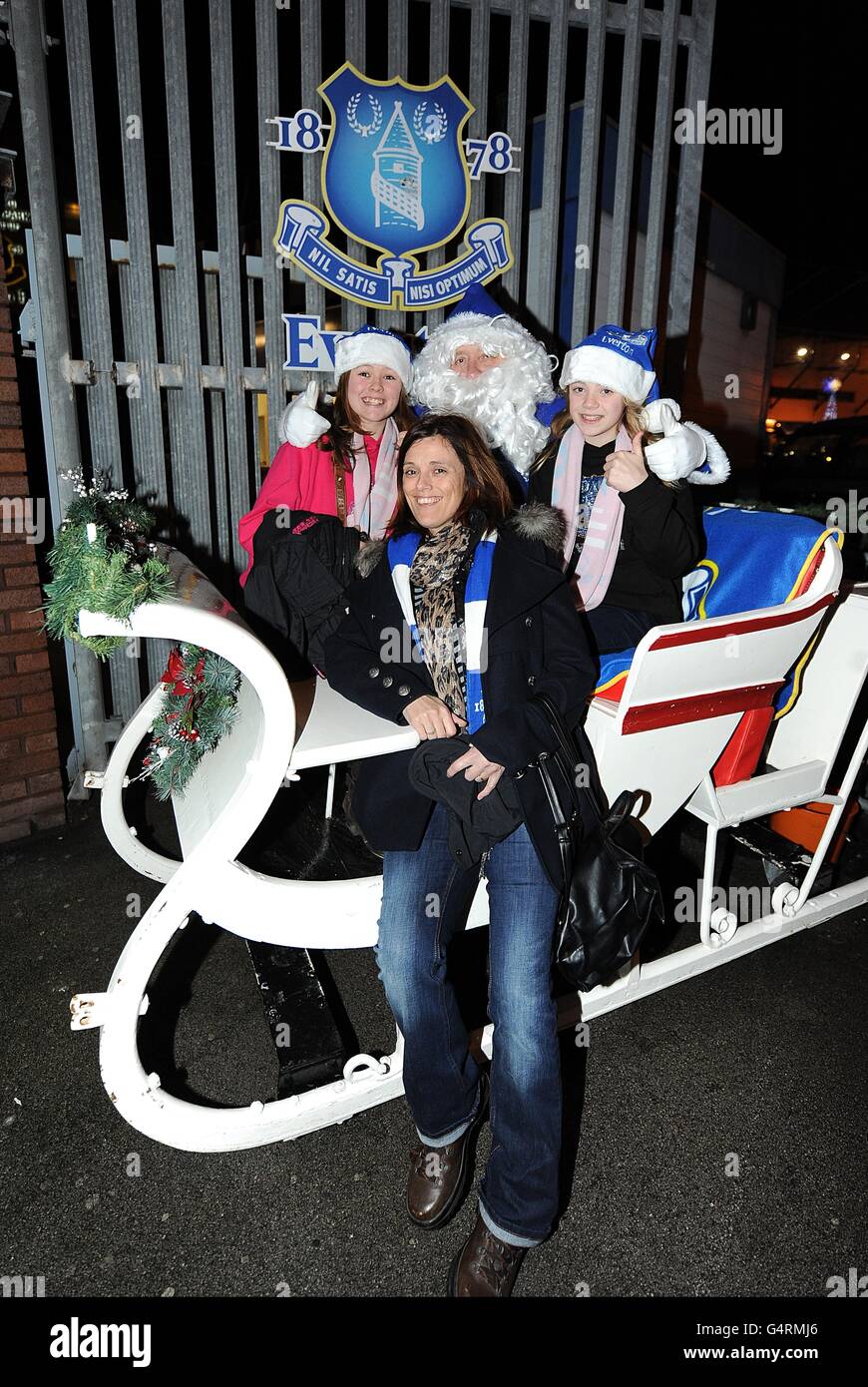 Everton fans pose for photographs with Blue Santa in his sleigh outside ...