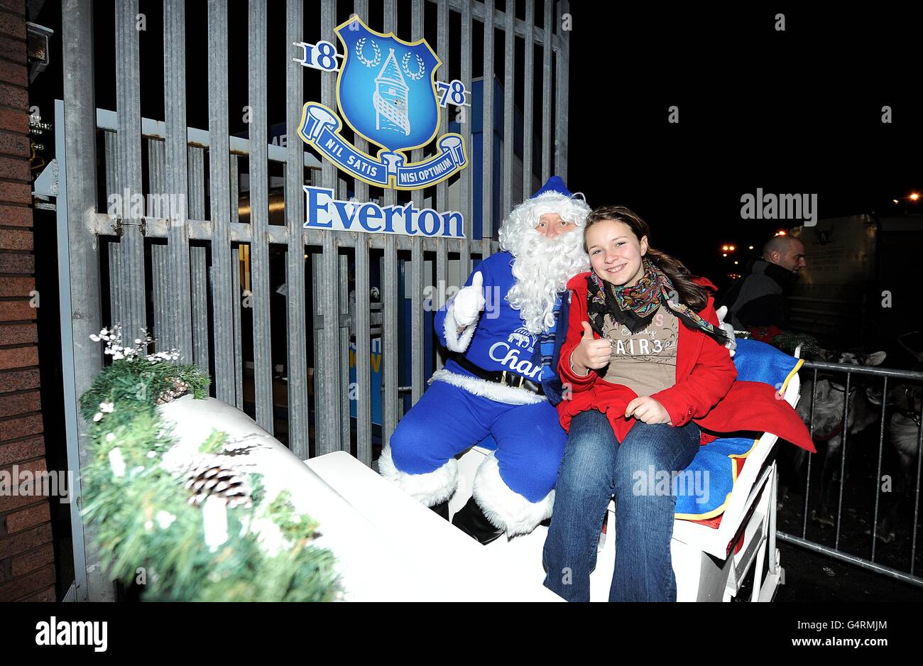 Everton fans pose for photographs with Blue Santa in his sleigh outside ...