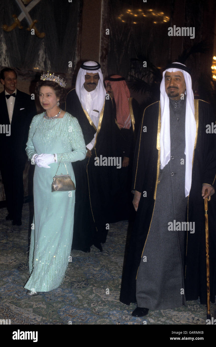 Queen Elizabeth II walking with King Khalid, right, when she and the ...