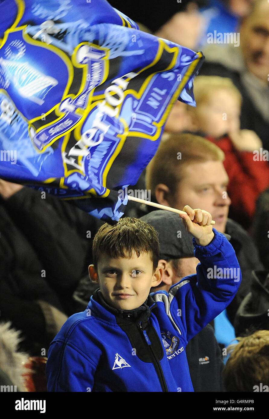 A young everton fan waves flag in stands hi-res stock photography and ...