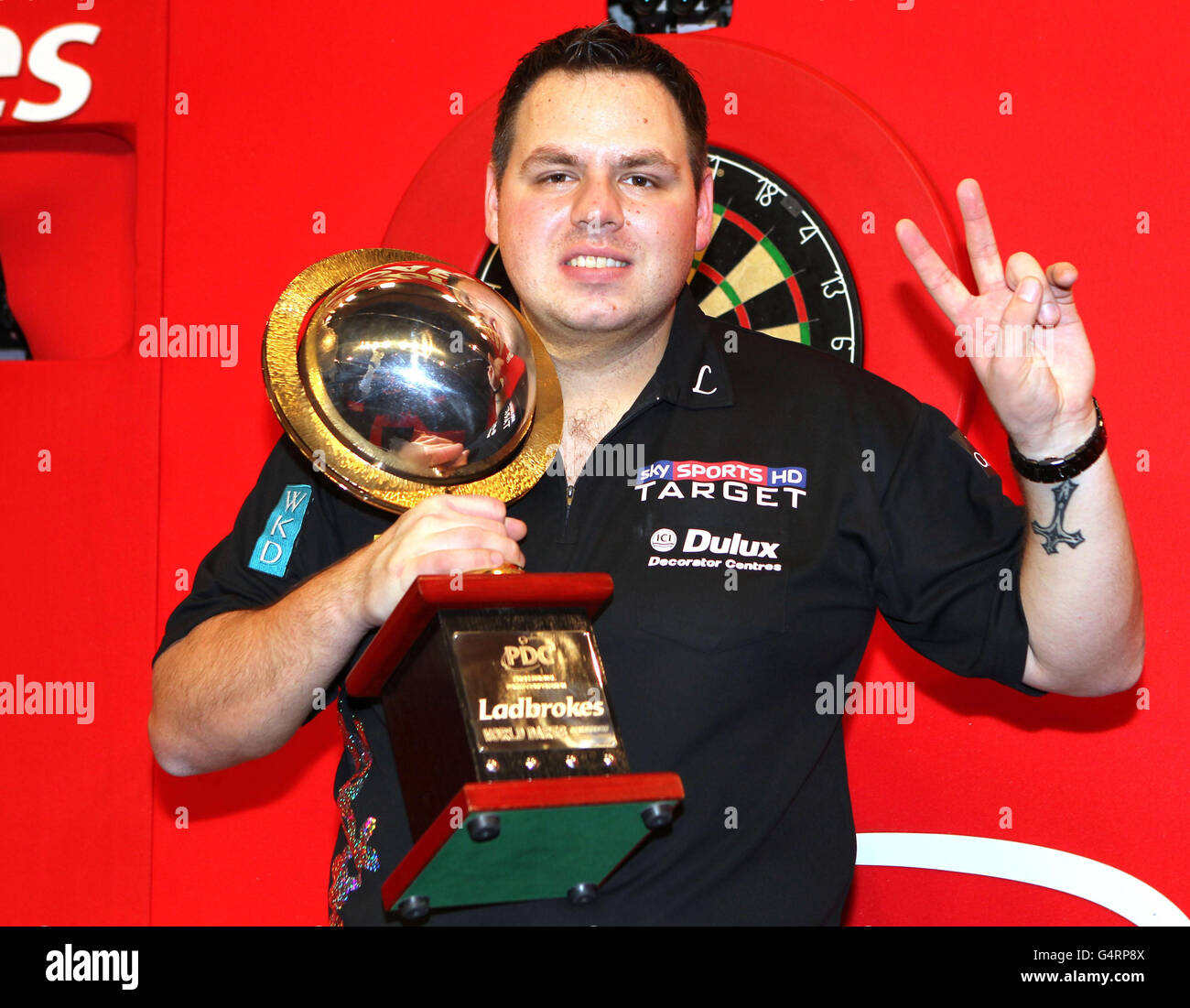 Adrian Lewis celebrates with his trophy after defeating Andy Hamilton ...