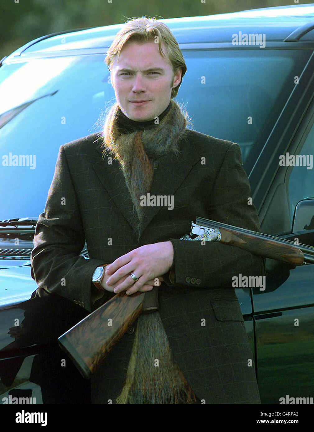 Lead singer of Boyzone, Ronan Keating poses with a shotgun in front of ...